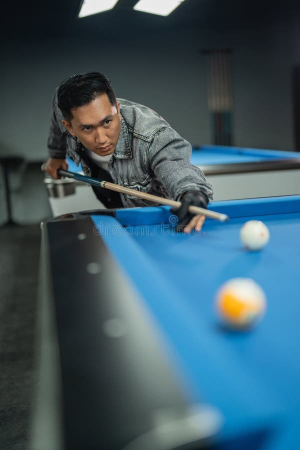 Male Billiard Player Poking the Ball Seriously Using the Cue Stick ...