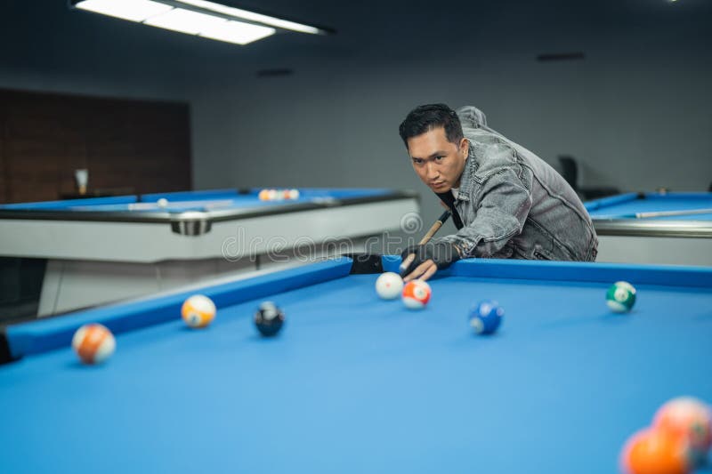 Male Billiard Player Poking the Ball Seriously Using the Cue Stick ...