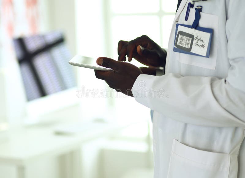 Male Black Doctor Worker With Tablet Computer Standing In Hospital ...