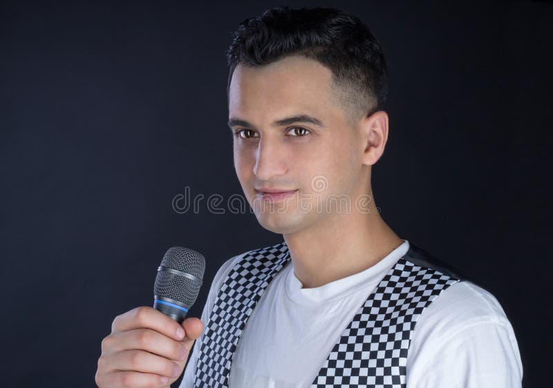 Male Black-haired Pop Singer Performs Singing To Microphone Stock Image ...