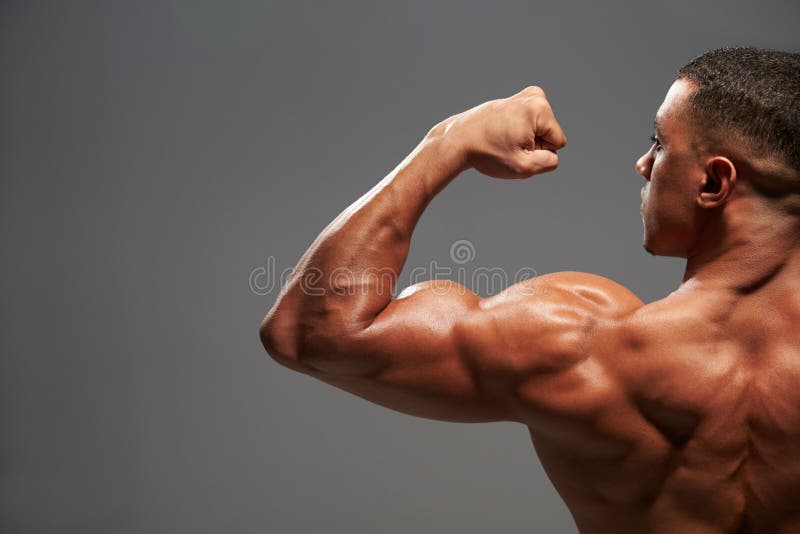 Male Bodybuilder Flexing Bicep, Back View with Copy Space Stock Photo ...