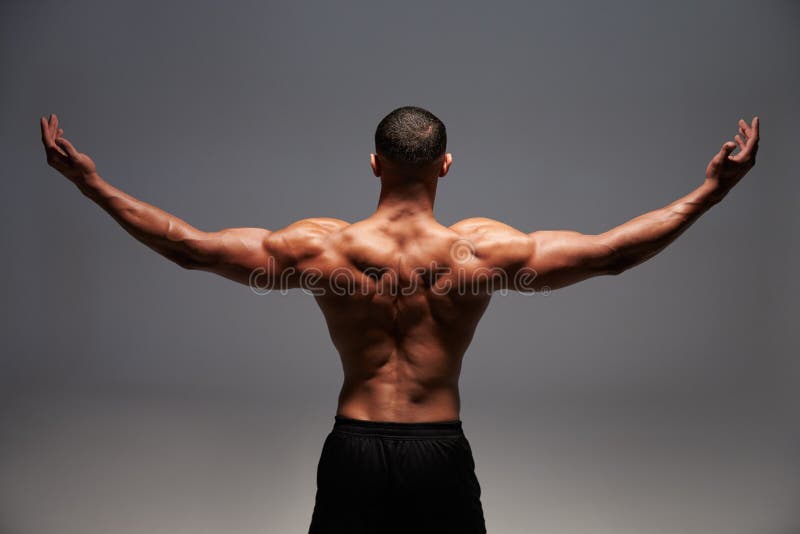 Male Bodybuilder Raising His Arms, Back View Stock Photo - Image of ...