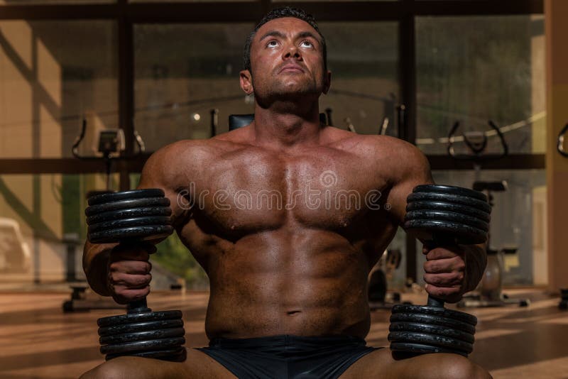 Bodybuilder Doing Heavy Weight Exercise for Biceps with Dumbbell Stock ...