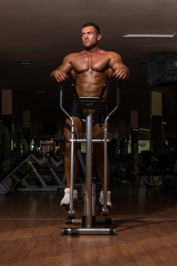 Male Bodybuilder Using the Elliptical Machine Stock Image - Image of ...