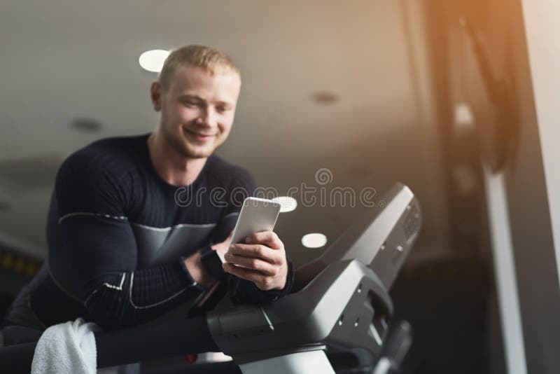 Male Bodybuilder Using Smartphone during Workout Stock Photo - Image of ...