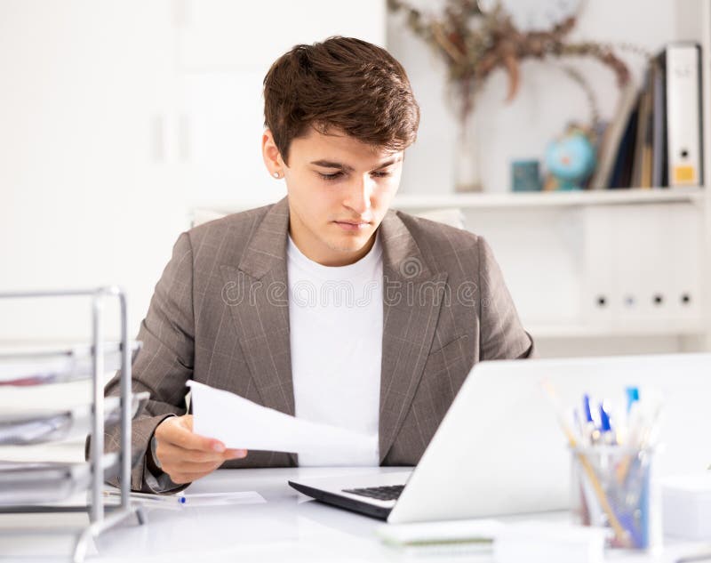 Male Bookkeeper Doing Paperwork in Workplace in Office - Checks ...