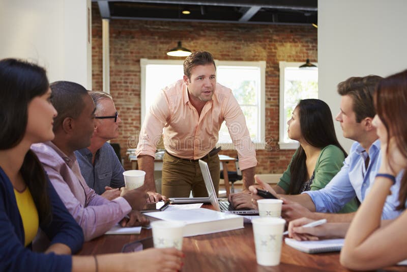 Male Boss Addressing Office Workers at Meeting Stock Photo - Image of ...