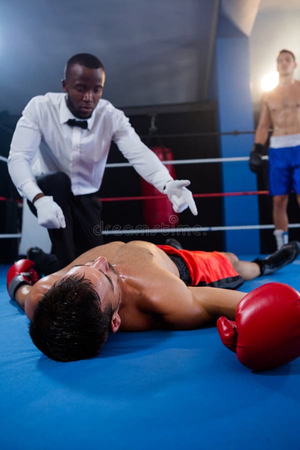 Male Boxer Looking while Referee Counting by Athlete Stock Photo ...