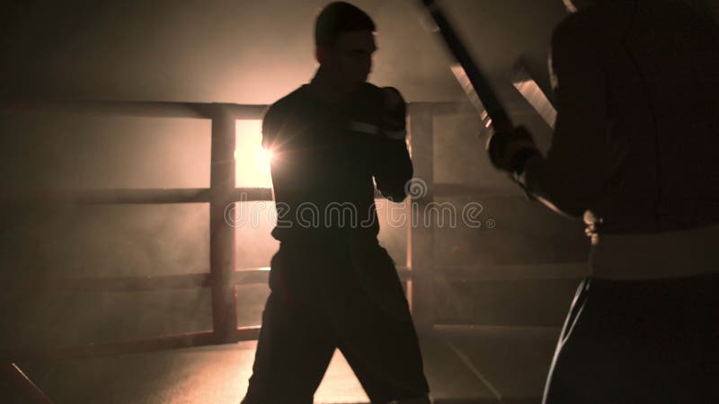 A Male Boxing Trainer Gives Lessons And Trains A Young Boxer In The