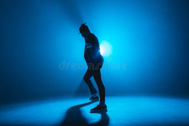 Male Break Dancer Performs on Blue Neon Stage His Expressive Dance ...