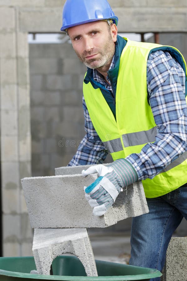 Male Builder Carrying Concrete Wall Stock Photo - Image of site ...