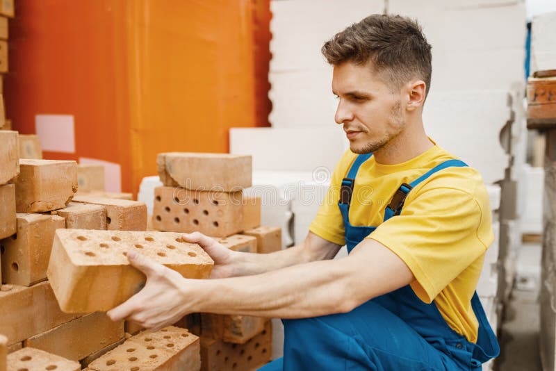 Male Builder Choosing Bricks in Hardware Store Stock Photo - Image of ...