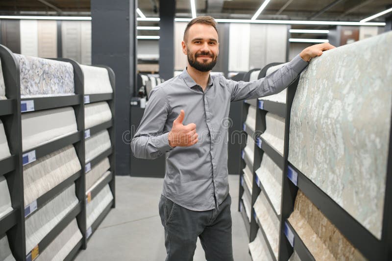 Male Builder Choosing Wallpapers in Hardware Store Stock Image - Image ...