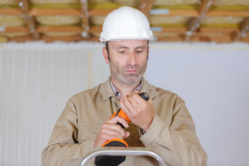 Male Builder Drilling Holes in Wall at Construction Site Stock Image ...