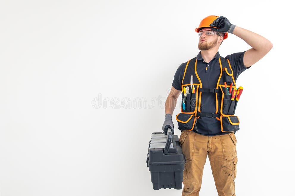 Male Builder. Electrical Engineer in Overalls and Helmet Holds Toolbox ...