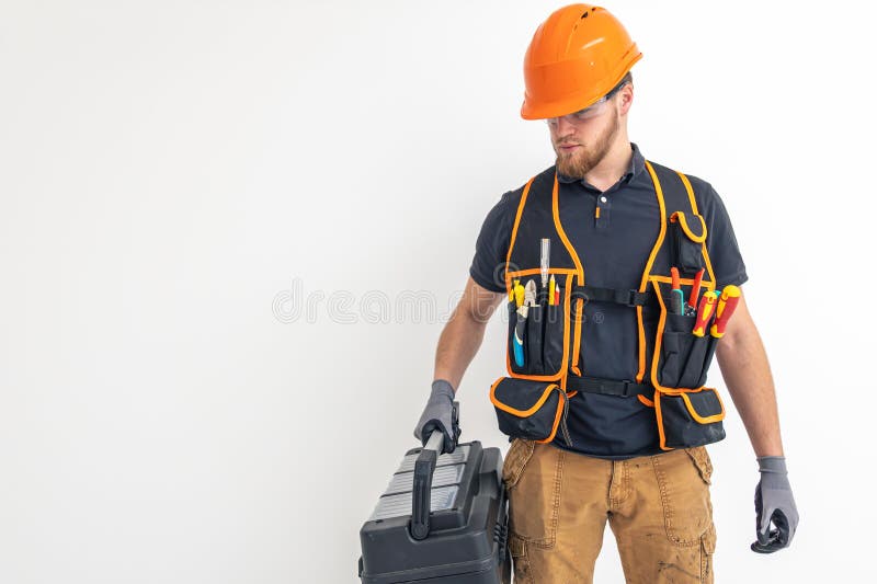 Male Builder. Electrical Engineer in Overalls and Helmet Holds Toolbox ...