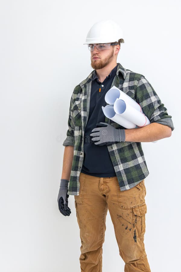 Male Builder. Engineer in Overalls and Helmet Holds Blueprints and ...
