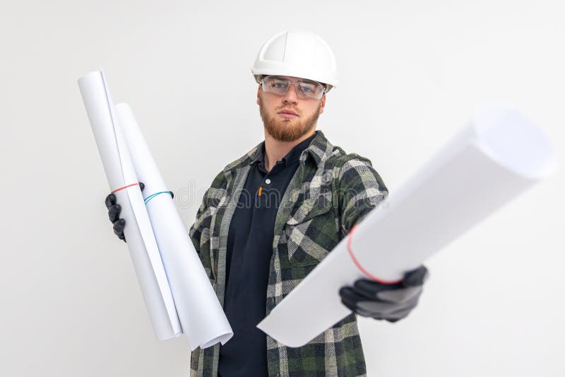 Male Builder. Engineer in Overalls and Helmet Holds Blueprints and ...