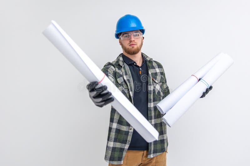 Male Builder. Engineer in Overalls and Helmet Holds Blueprints and ...