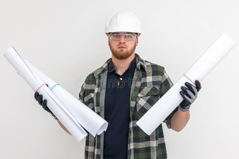 Male Builder. Engineer in Overalls and Helmet Holds Blueprints and ...
