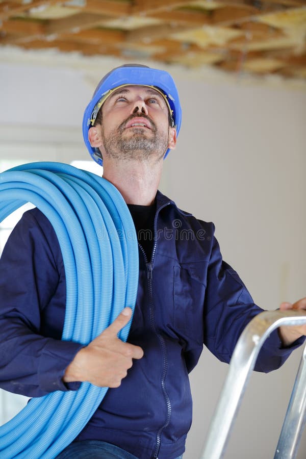 Male Builder Holding Hose Pipe Insulation Stock Photo - Image of grey ...