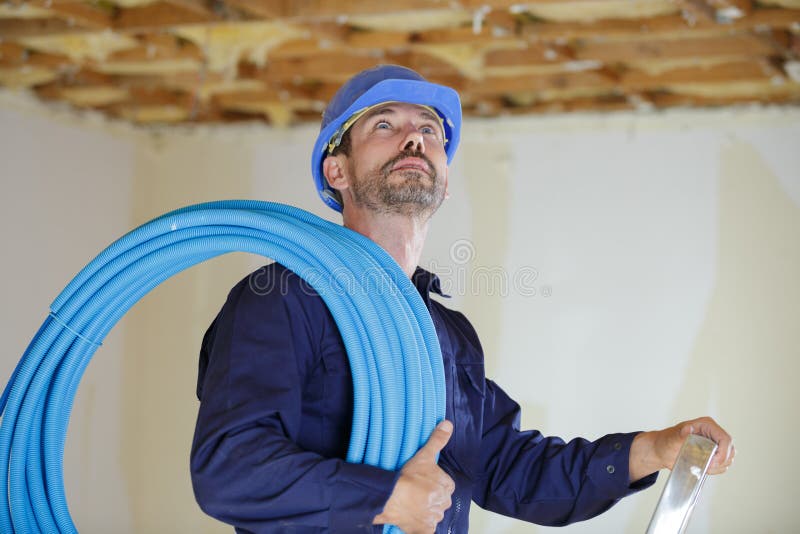 Male Builder Holding Hose Pipe Insulation Stock Image - Image of male ...