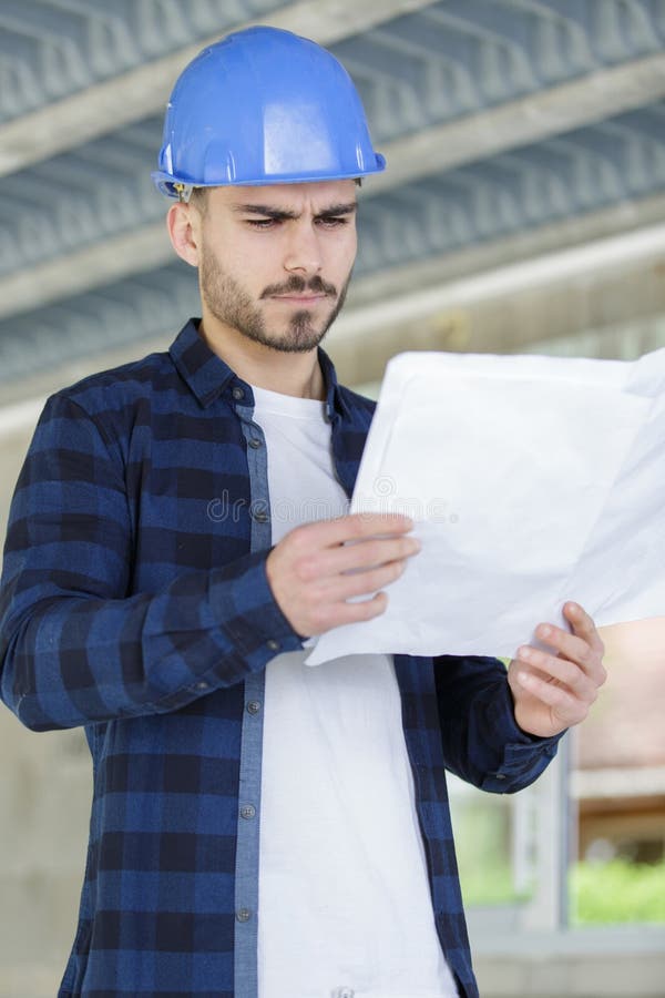 Male builder holds map stock photo. Image of waterproofing - 282354184