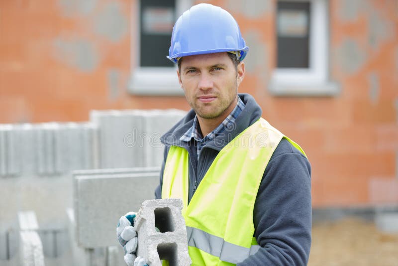 Male Builder Installing Concrete Blocks Stock Photo - Image of mortar ...