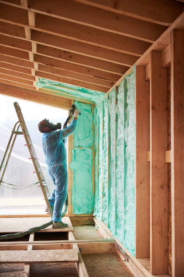 Worker Spraying Polyurethane Foam for Insulating Wooden Frame House ...