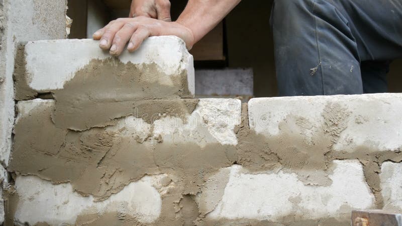 Male Builder Laying White Brick on Cement and Standing Wall. Hands of ...