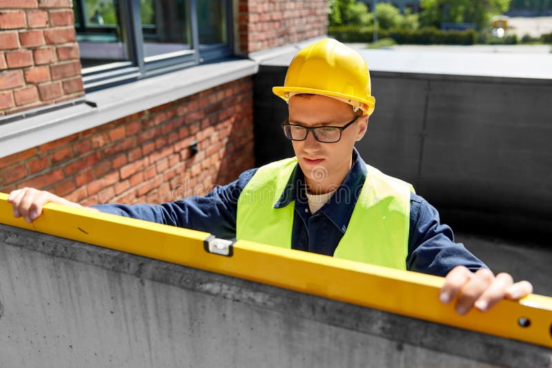 Male Builder with Level Measuring Wall Stock Image - Image of people ...