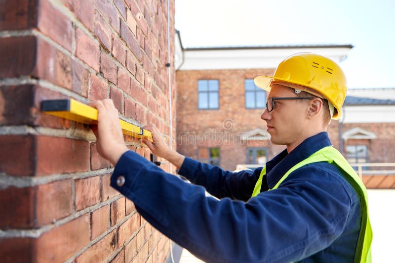 Male Builder with Level Measuring Wall Stock Photo - Image of person ...