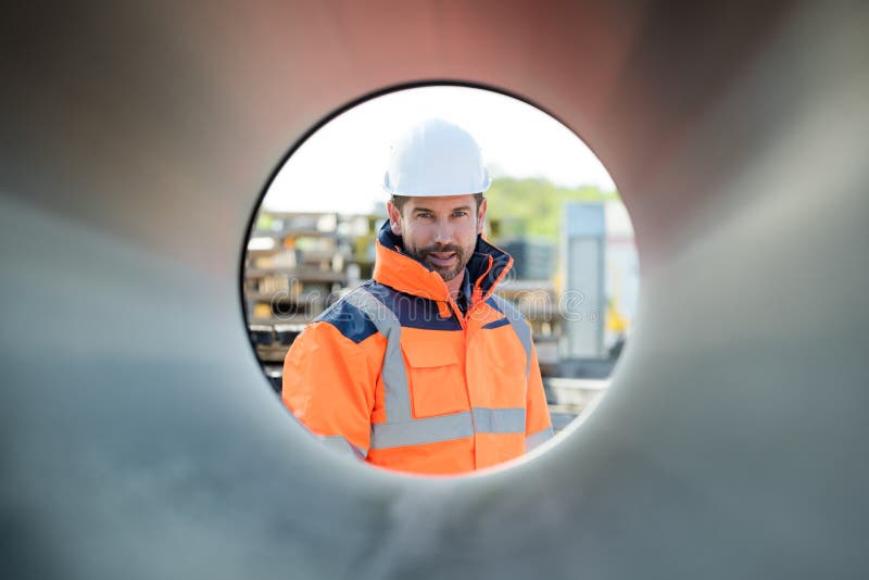 Male Builder Looking through Pipe Stock Image - Image of contractor ...