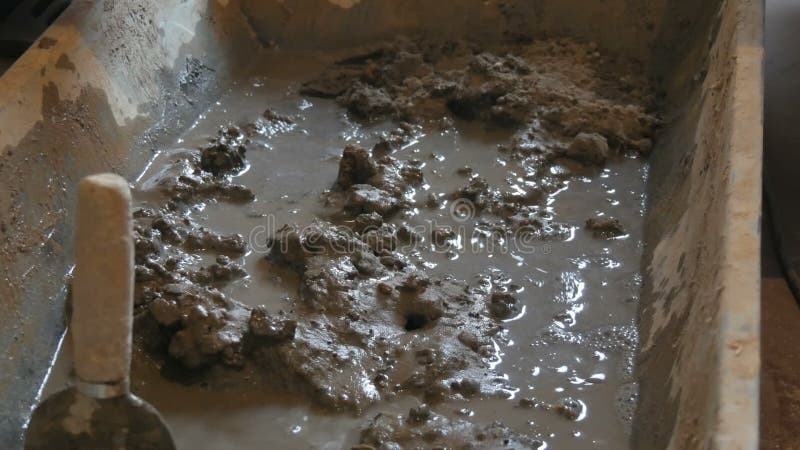 Male Builder Making Cement. Blends Cement Clay and Water, Mixing All it ...
