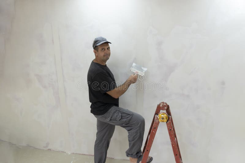 Male Builder, Master Office, Plasterer with a Tool in Working Clothes ...