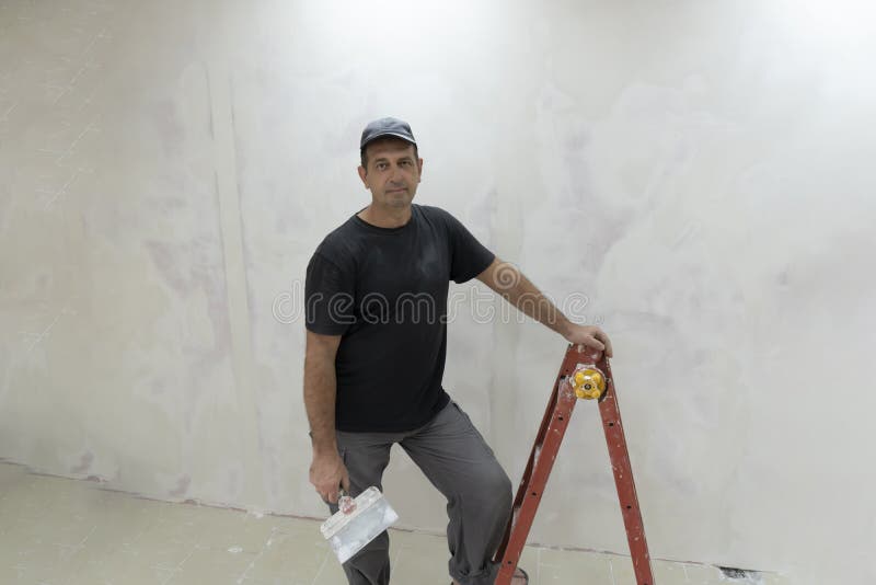 Male Builder, Master Office, Plasterer with a Tool in Working Clothes ...