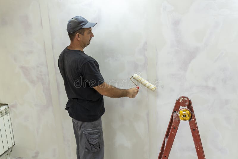 Male Builder, Master Office, Plasterer with a Tool in Working Clothes ...