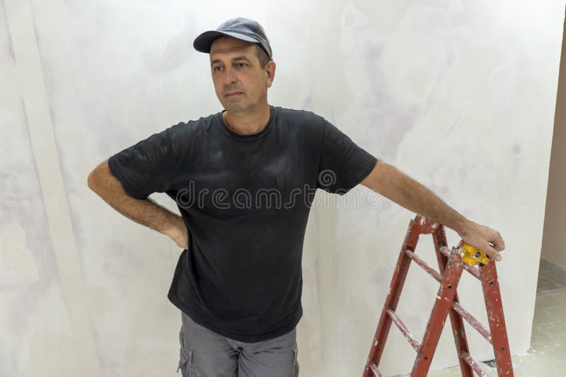 Male Builder, Master Office, Plasterer with a Tool in Working Clothes ...