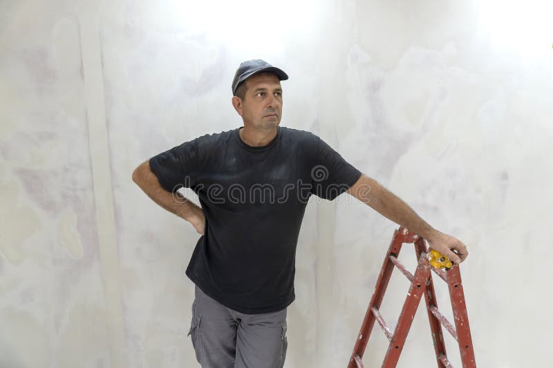 Male Builder, Master Office, Plasterer with a Tool in Working Clothes ...