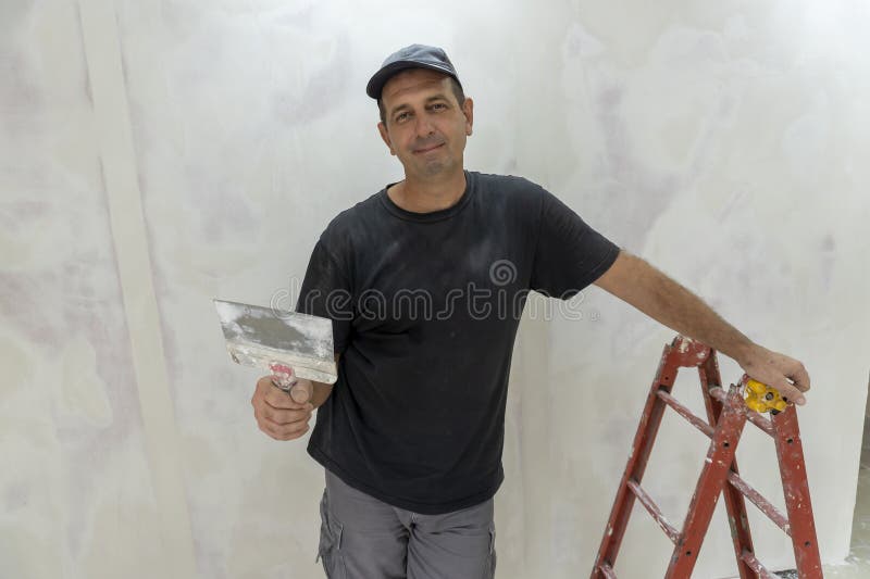 Male Builder, Master Office, Plasterer with a Tool in Working Clothes ...