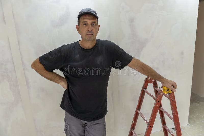 Male Builder, Master Office, Plasterer with a Tool in Working Clothes ...