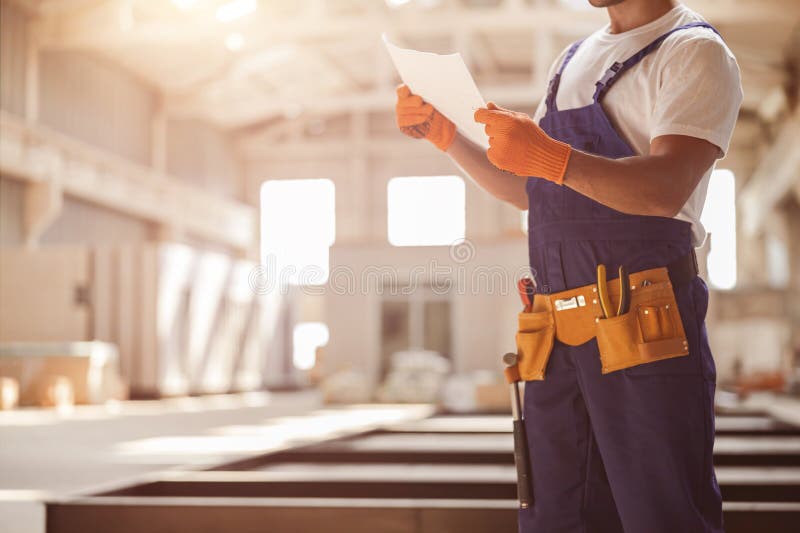 Male Builder Studying Architectural Plan at Construction Site Stock ...