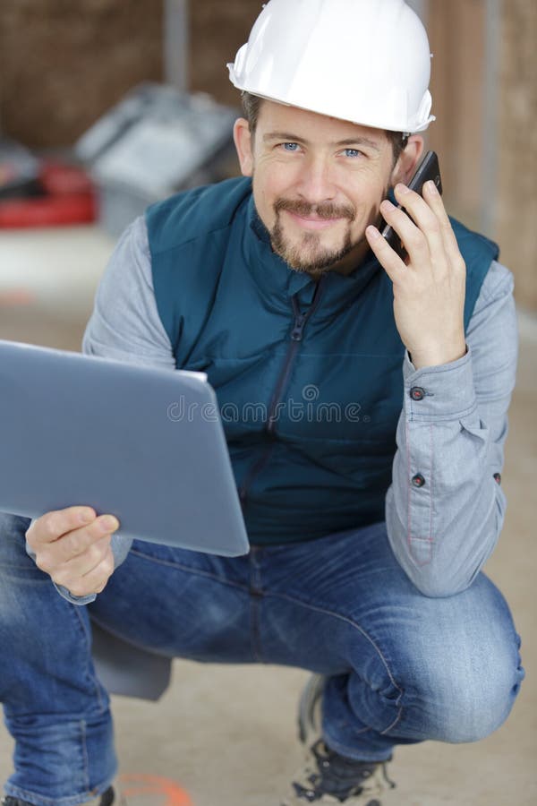 Male Builder Taking Notes on Clipboard As Talking on Phone Stock Image ...