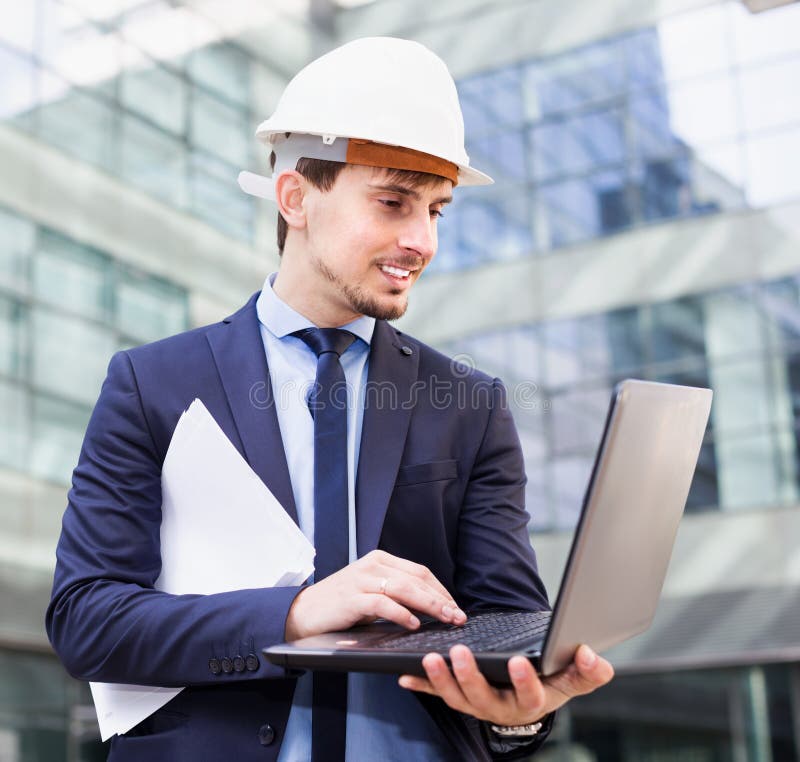 Male Builder Talking about Work at the Laptop Stock Image - Image of ...