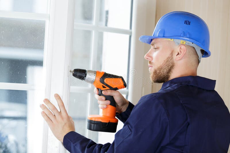 Male builder using drill stock photo. Image of contractor - 272191048