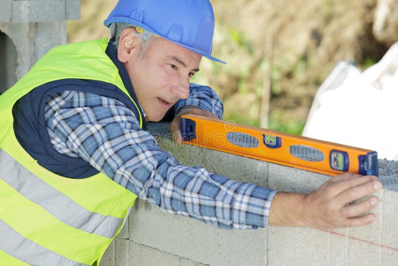 Male Builder Using Level on Wall Stock Photo - Image of manual ...
