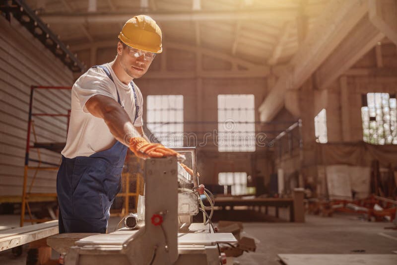 Male Builder Using Woodworking Machine in Workshop Stock Photo - Image ...