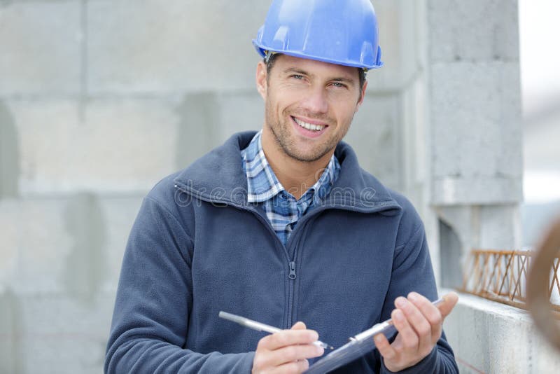 Male Builder Writing on Clipboard Stock Image - Image of order ...