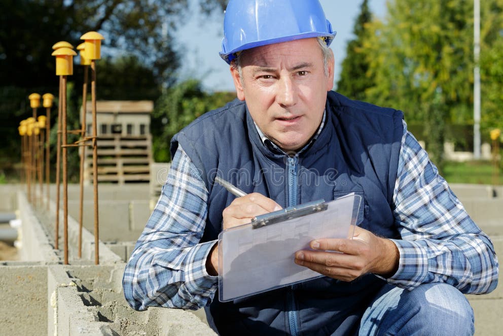 Male builder writing notes stock photo. Image of white - 204735910