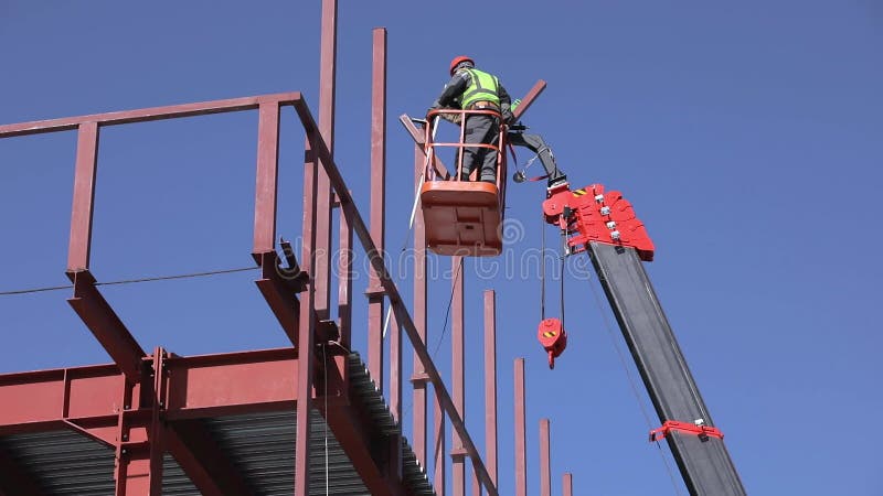 Male Builders Work on the Facade of the Building in a Suspended Cradle ...